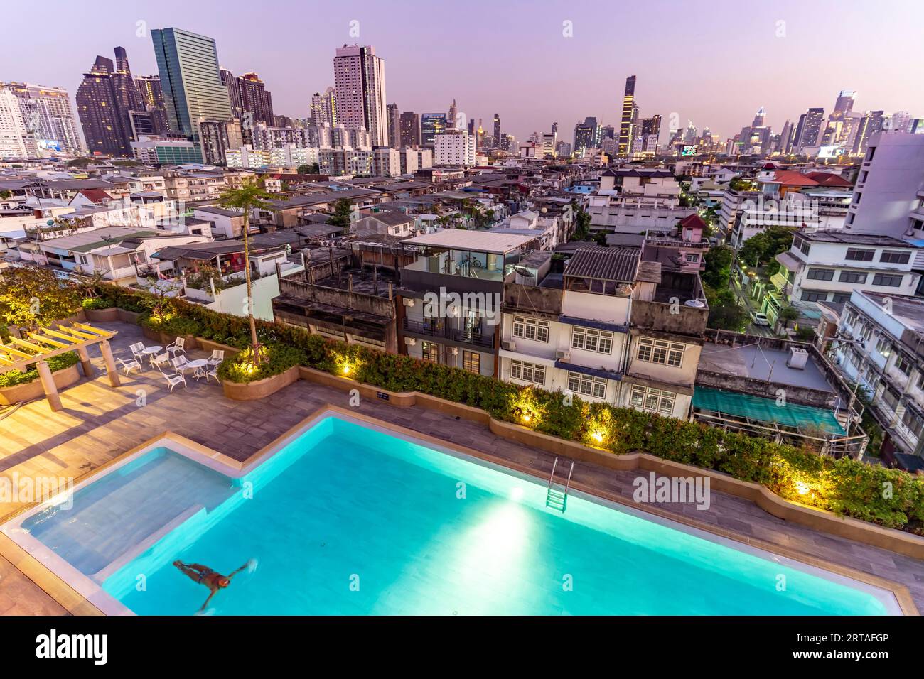 Illuminated swimming pool in front of Bangkok city view and skyline at ...
