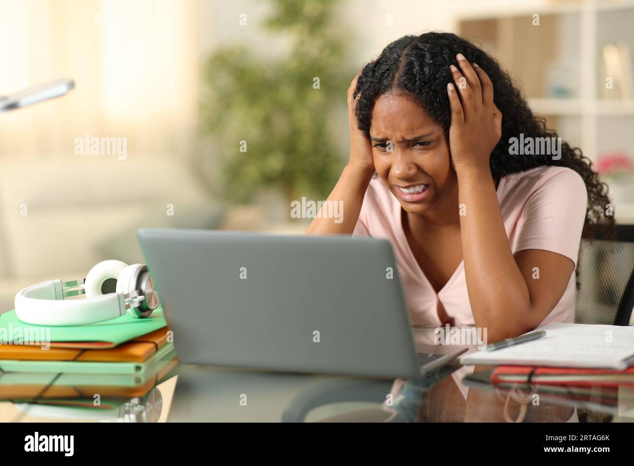 Overwhelmed black student complaining using laptop at home Stock Photo ...
