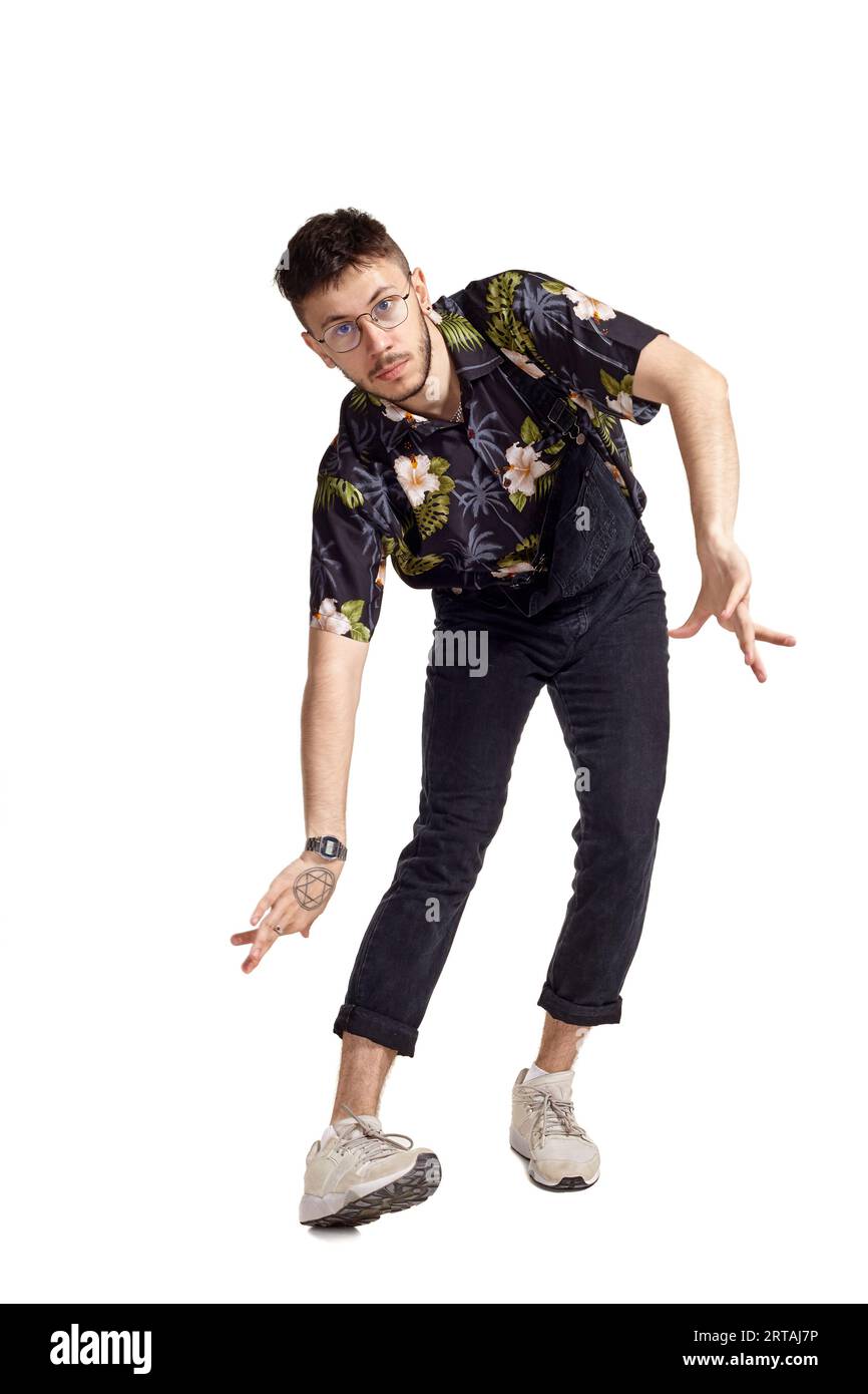 Full-length portrait of a funny guy dancing in studio isolated on white ...