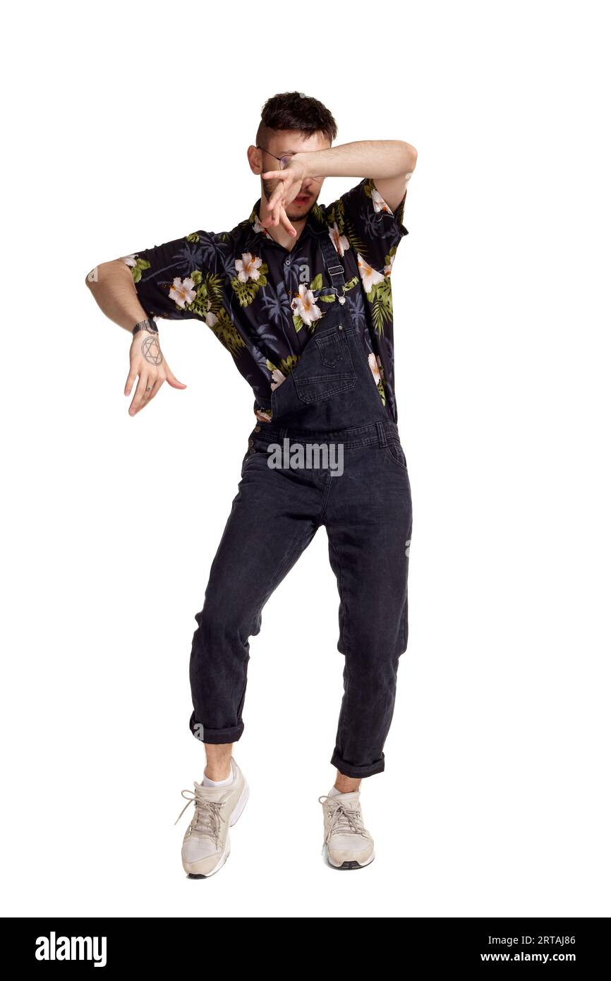 Full-length portrait of a funny guy dancing in studio isolated on white ...