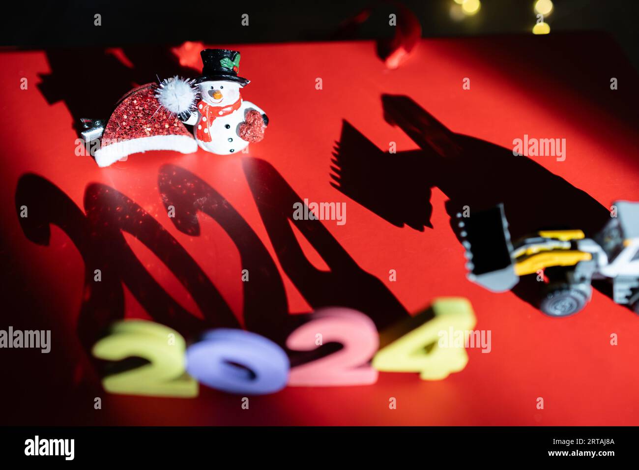 toy model of a construction excavator, the numbers 2024 and a ...