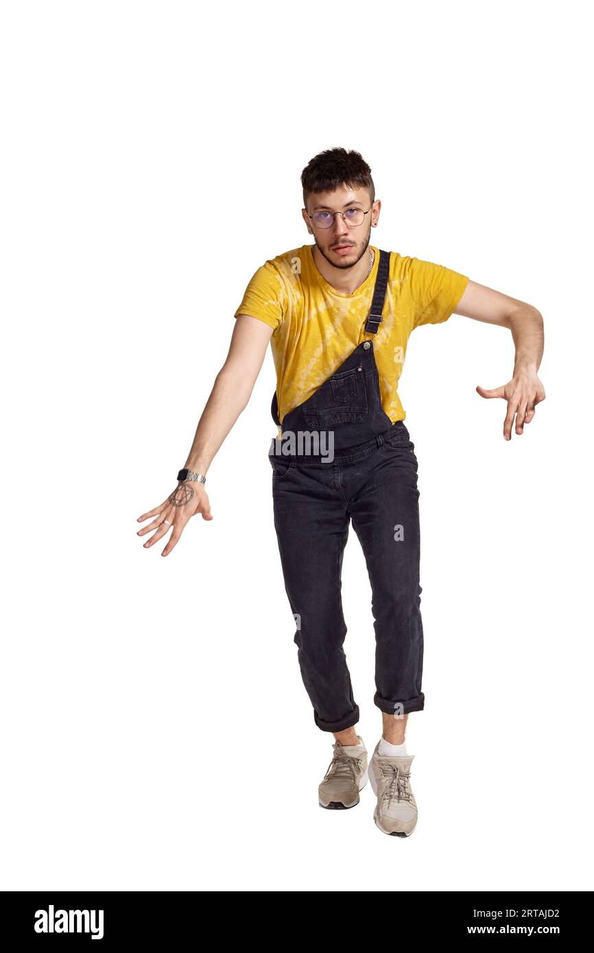Full-length portrait of a funny guy dancing in studio isolated on white ...