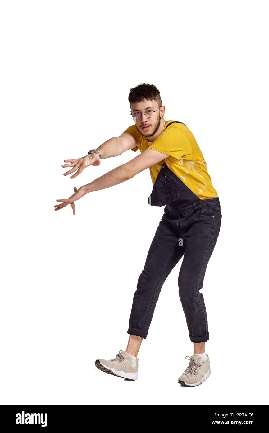 Full-length portrait of a funny guy dancing in studio isolated on white ...