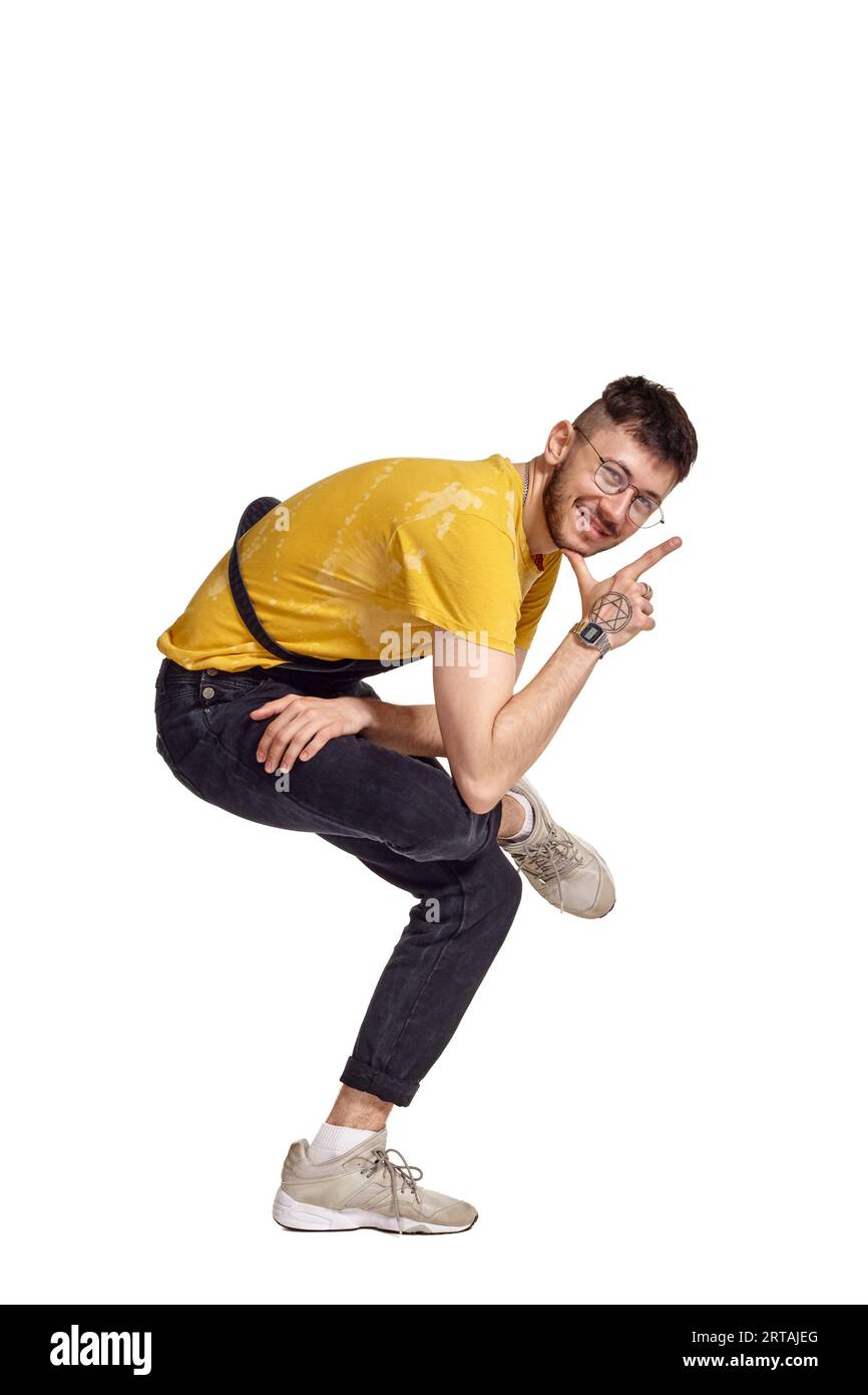Full-length portrait of a funny guy dancing in studio isolated on white ...