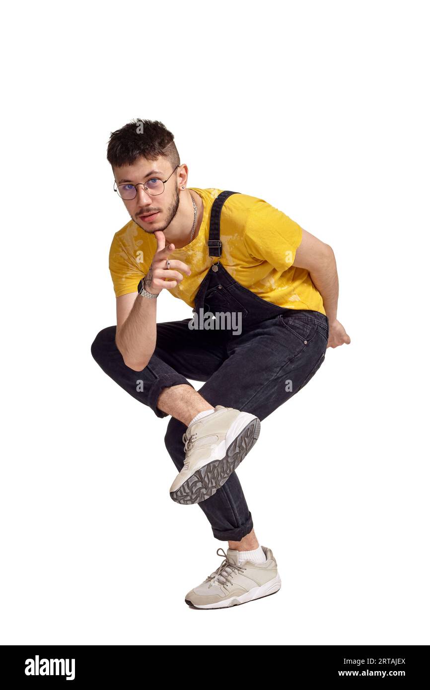 Full-length portrait of a funny guy dancing in studio isolated on white ...