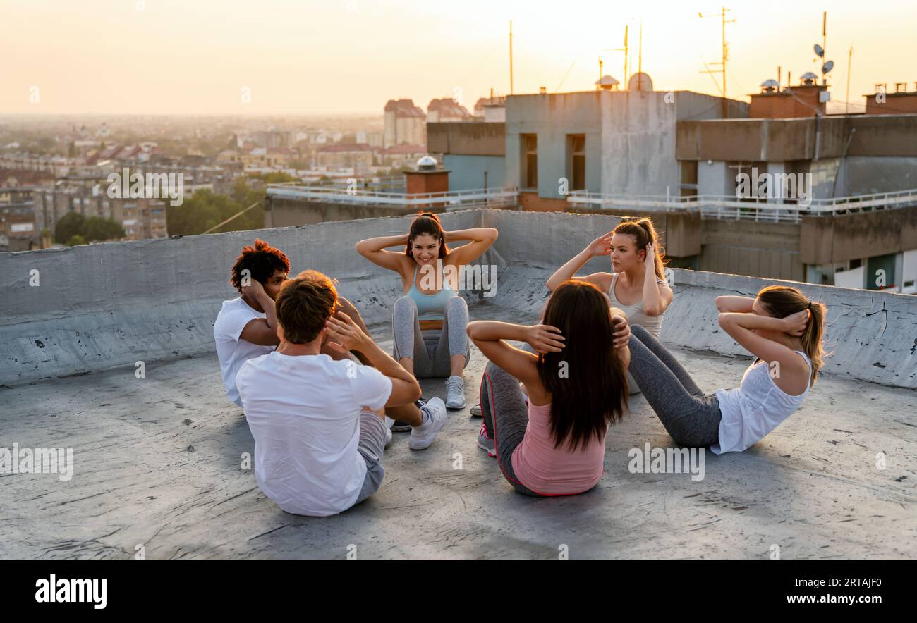 Group of fit healthy friends, people exercising together outdoor Stock ...