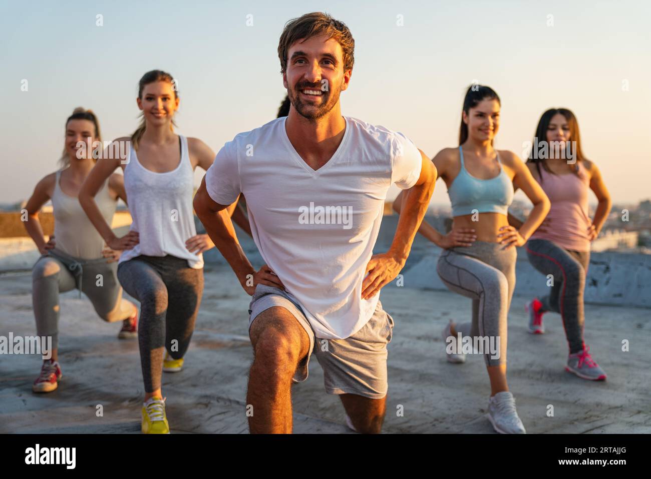 Group of fit healthy friends, people exercising together outdoor Stock ...