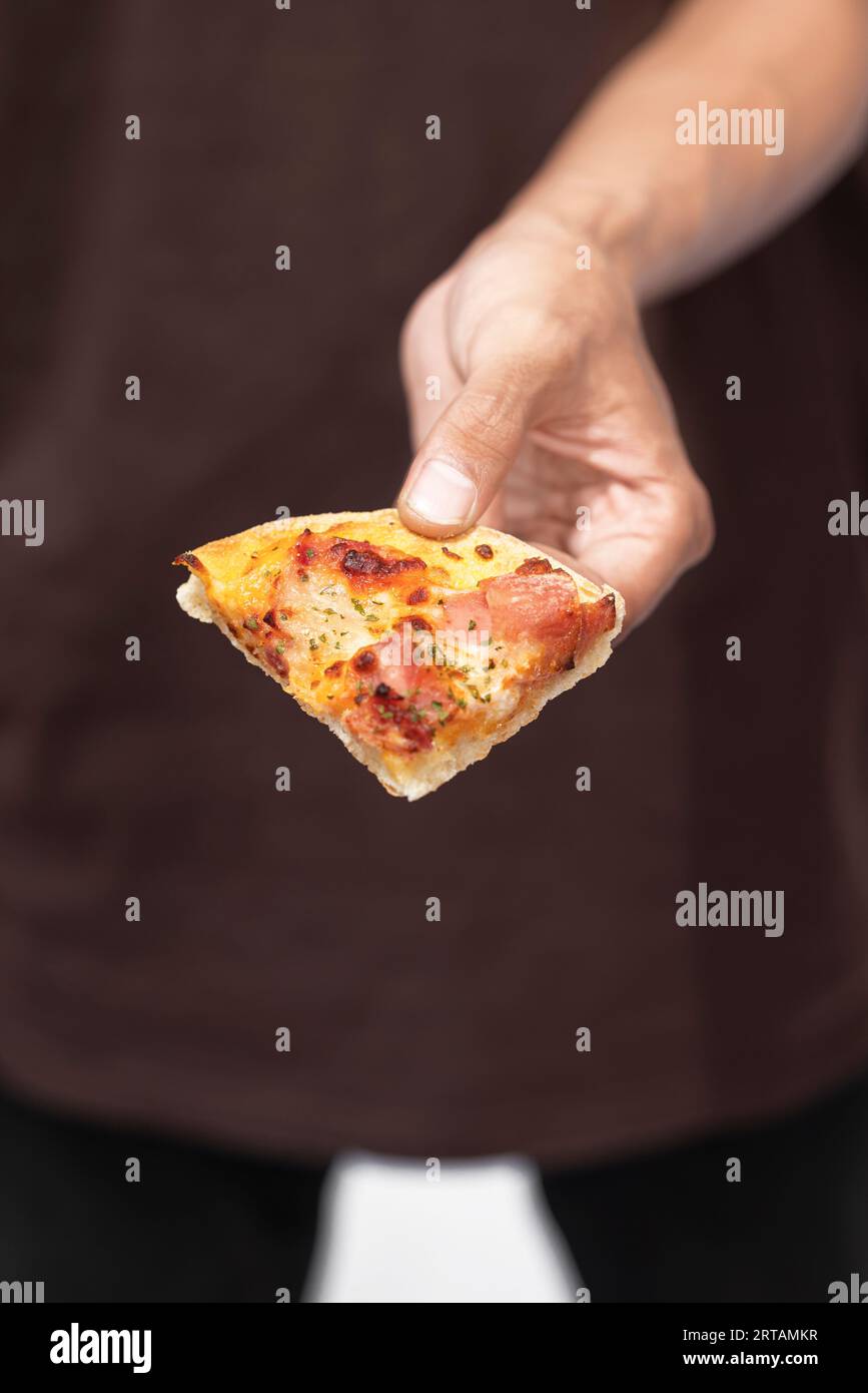 A human hand holding a slice of pizza with a white background Stock ...