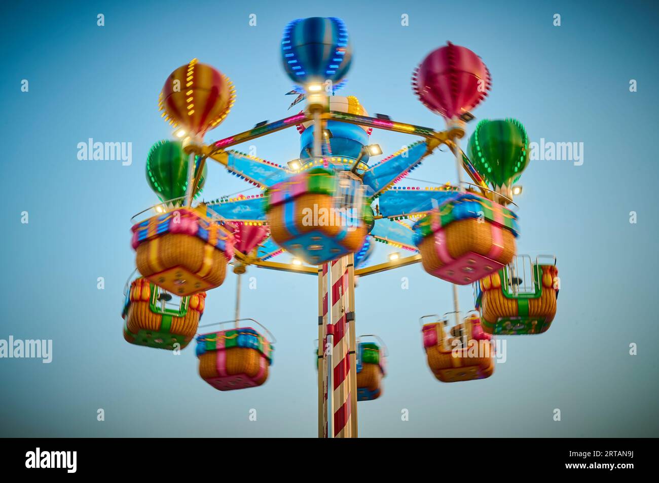 Hot air balloon vertical rounabout on fun fair Stock Photo - Alamy