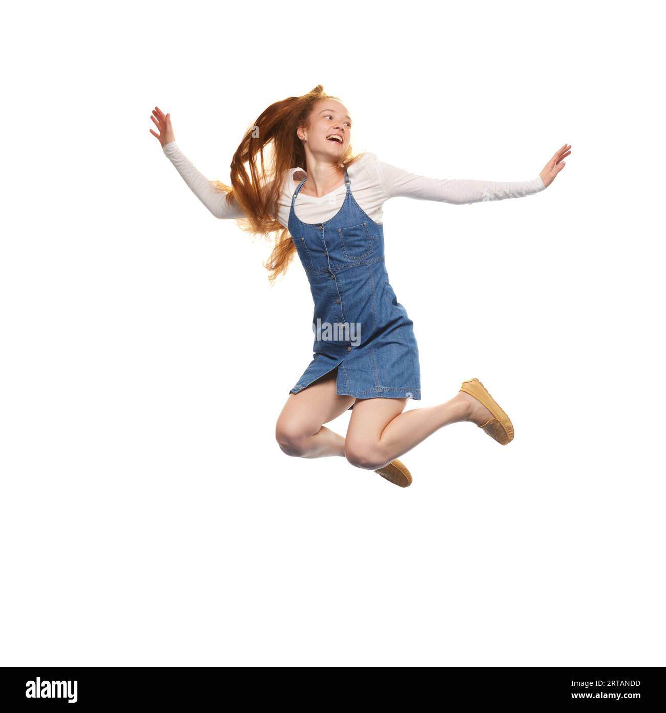 Happy, smiling, psiive redhead girl cheerfully jumping isolated on ...