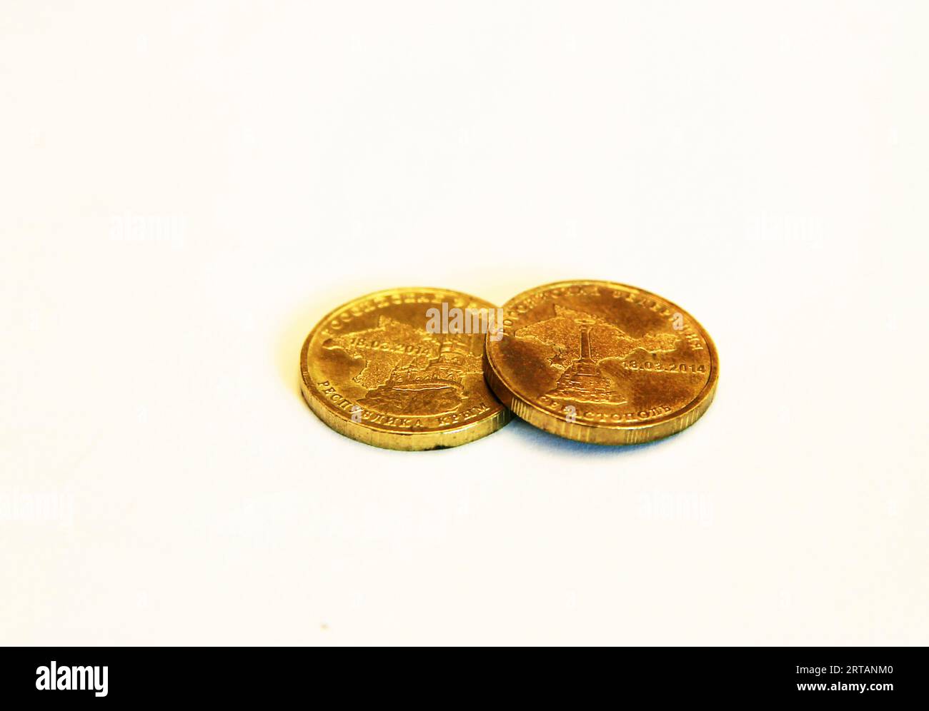 Stacks of Russian coins laying on the white background. Ten rubles with ...