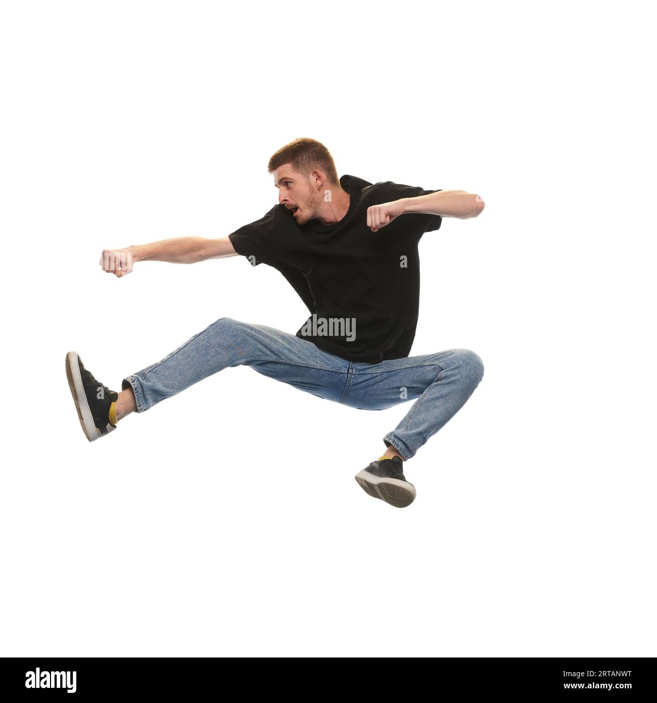 Overcoming difficulties. Young man jumping in fighting pose isolated on ...