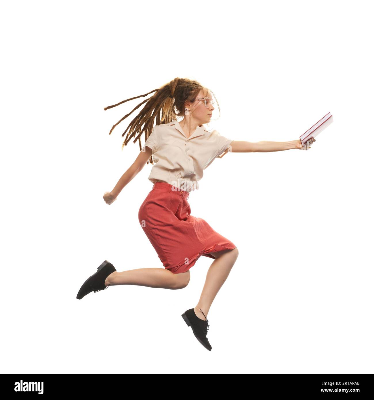 Young girl, employee with books jumping isolated on white background ...