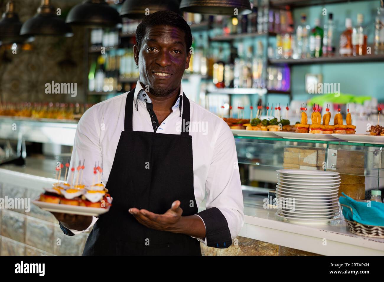 Professional african american waiter holding serving tray for ...