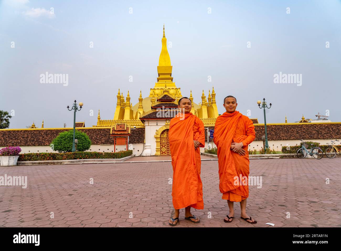 Monks pose in front of the Pha That Luang - The national symbol of Laos ...
