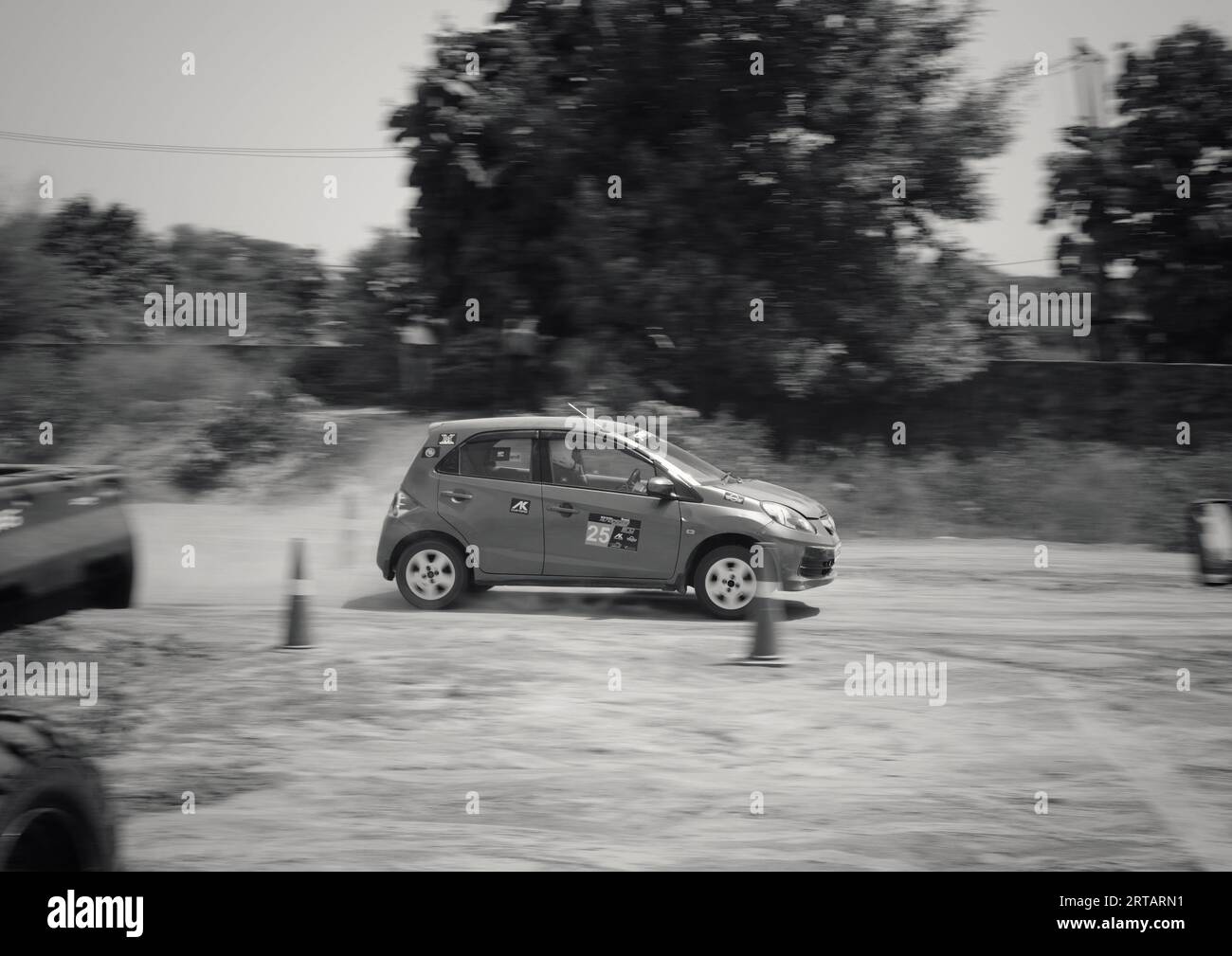 Honda Brio being driven through an autocross stage on dirt Stock Photo ...