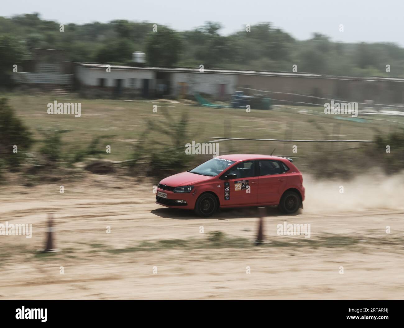 Red Volkswagen Polo being driven through an autocross stage on dirt ...