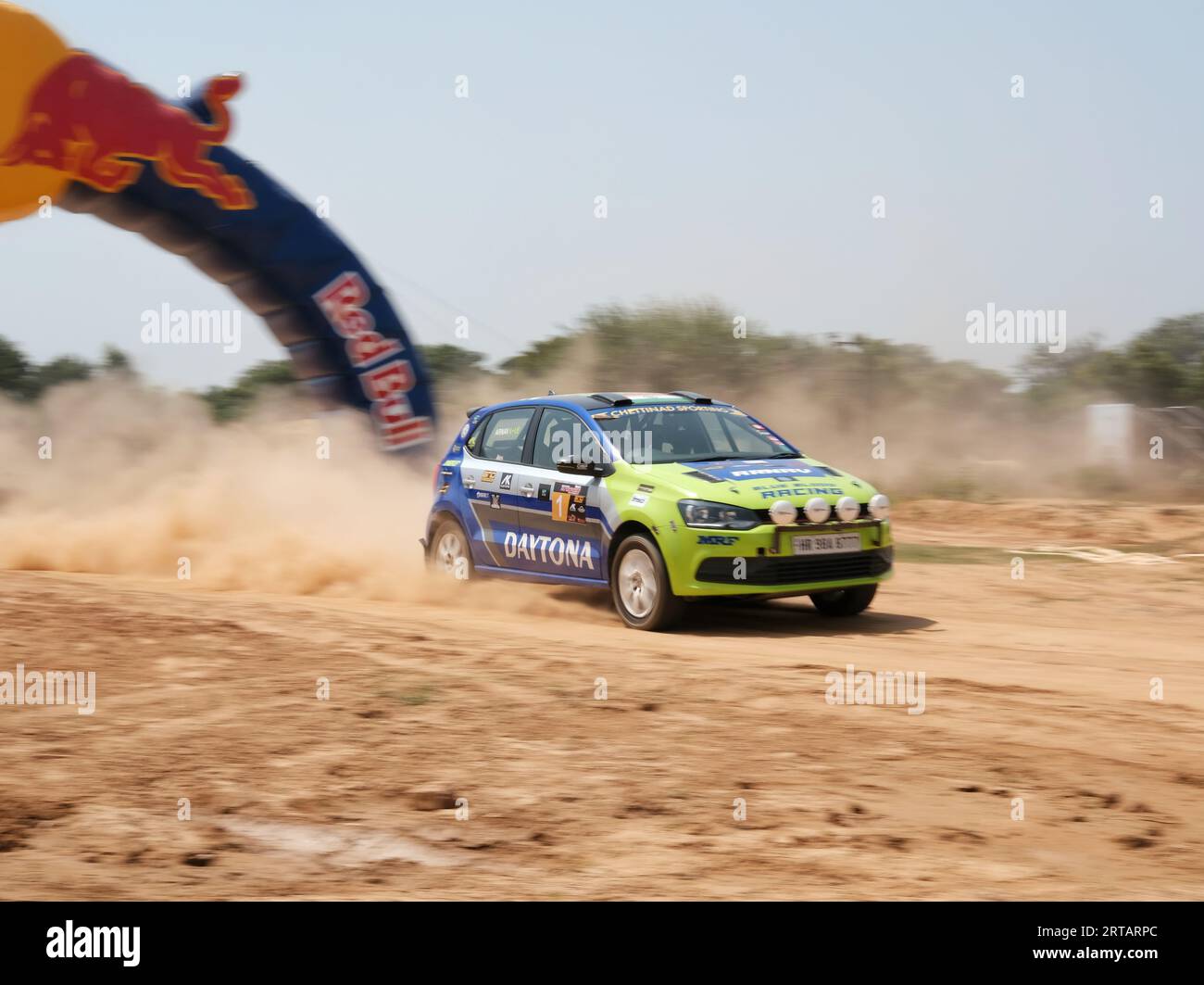 Green Volkswagen Polo being driven through an autocross stage on dirt ...