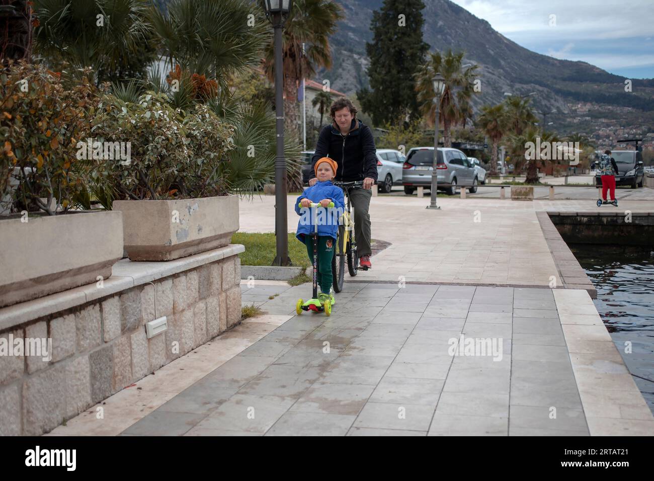 Montenegro, Apr 17, 2023: Father and son riding bicycle and kick ...