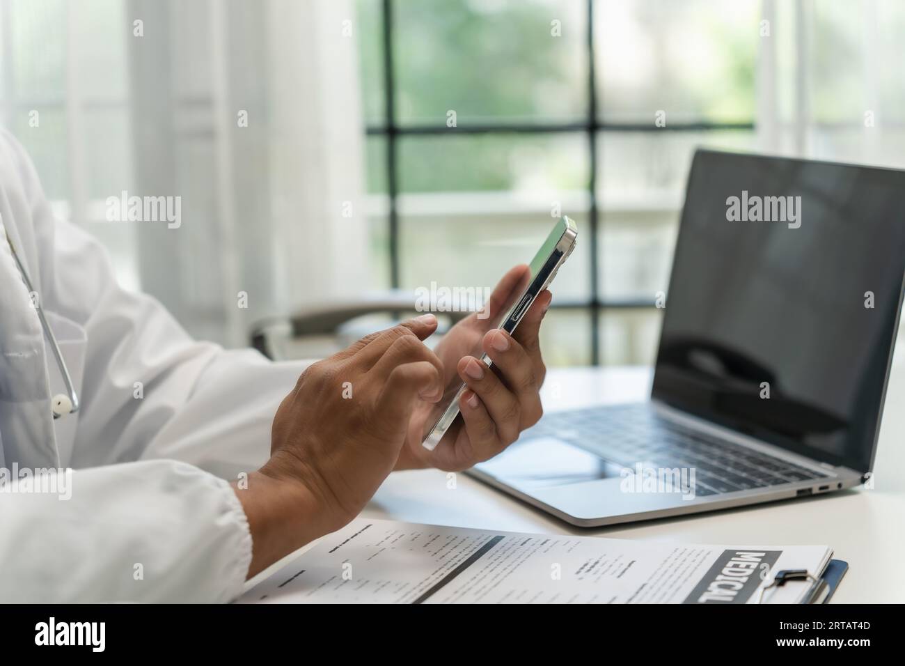 Doctor Smiling working with mobile phones and remote online services at ...