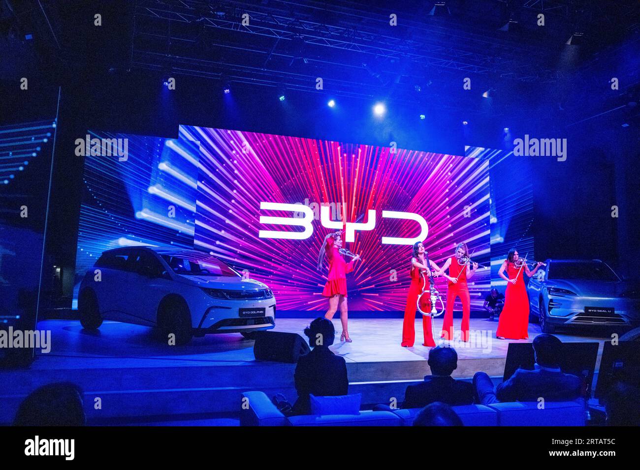 Female musicians playing on stage with the BYD Dolphin and BYD Seal U ...