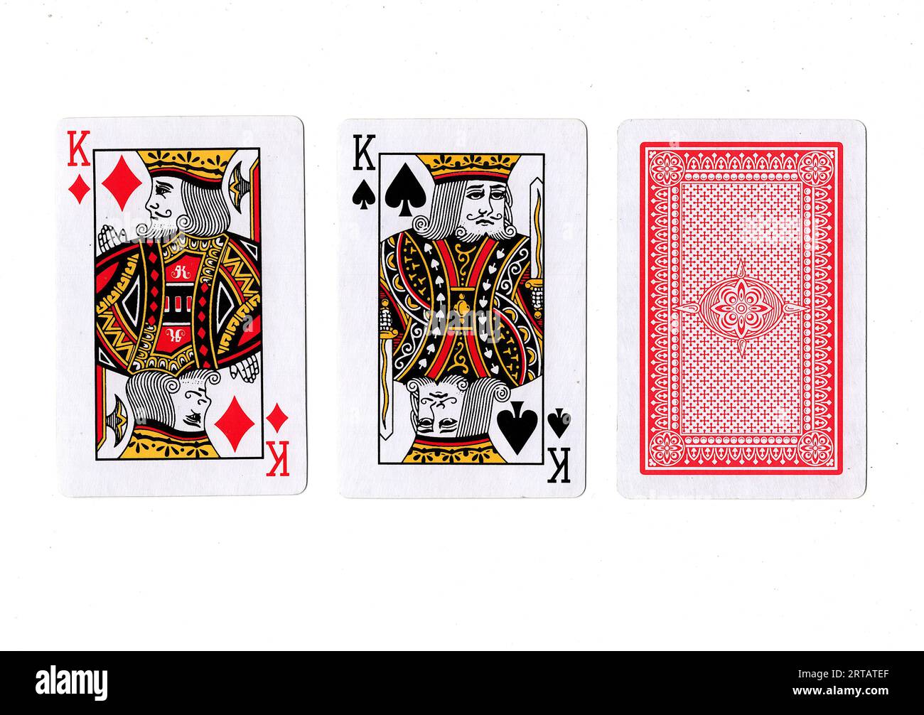 A hand of three playing cards revealing two kings on a white background ...