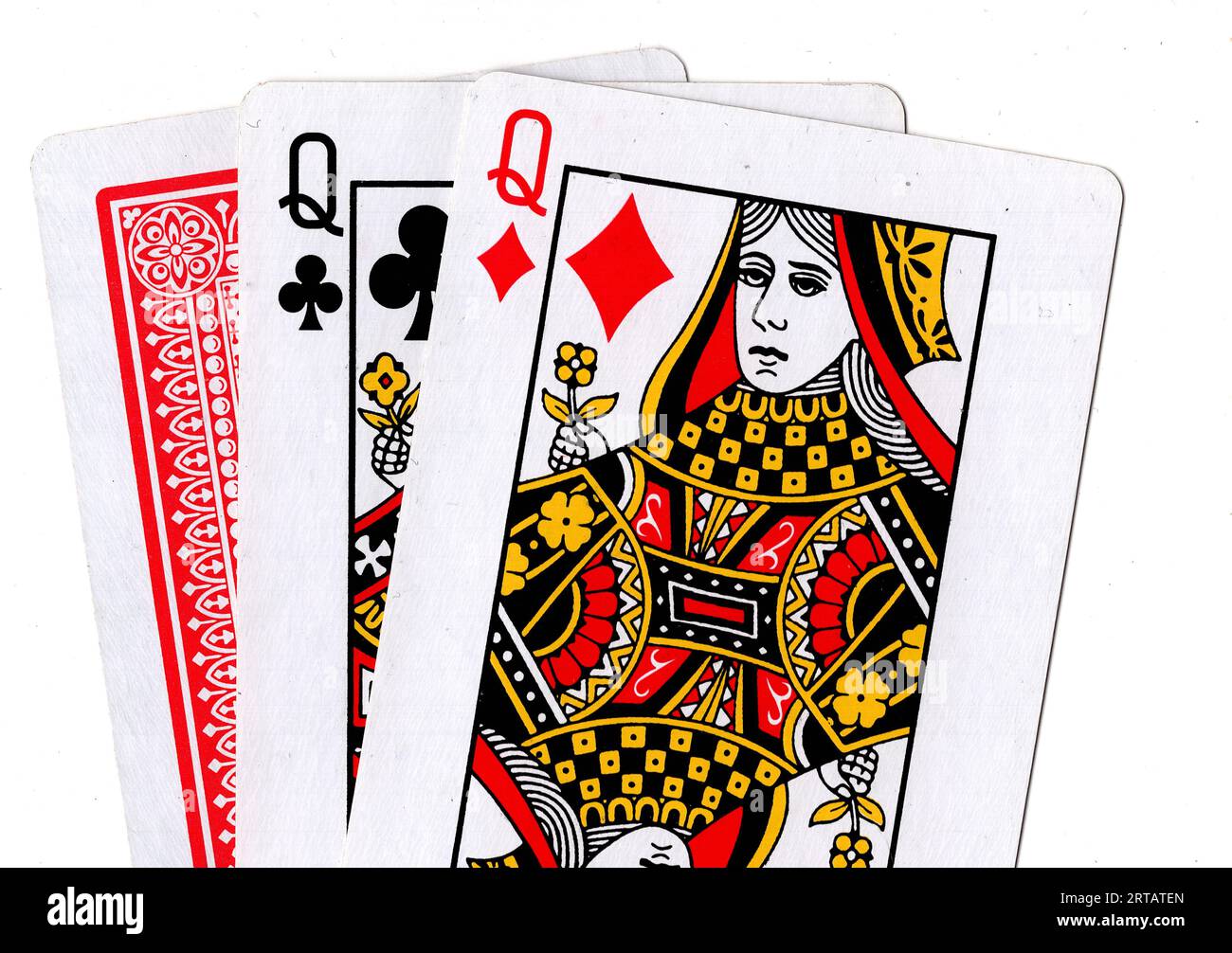 A hand of three playing cards revealing two queens on a white ...