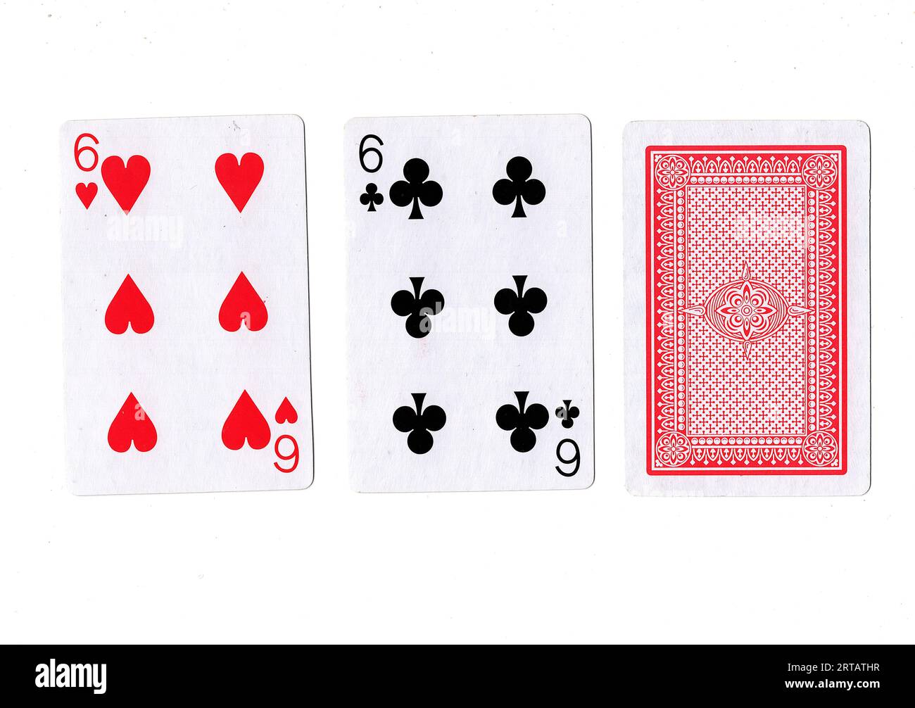 A hand of three playing cards revealing two sixes on a white background ...
