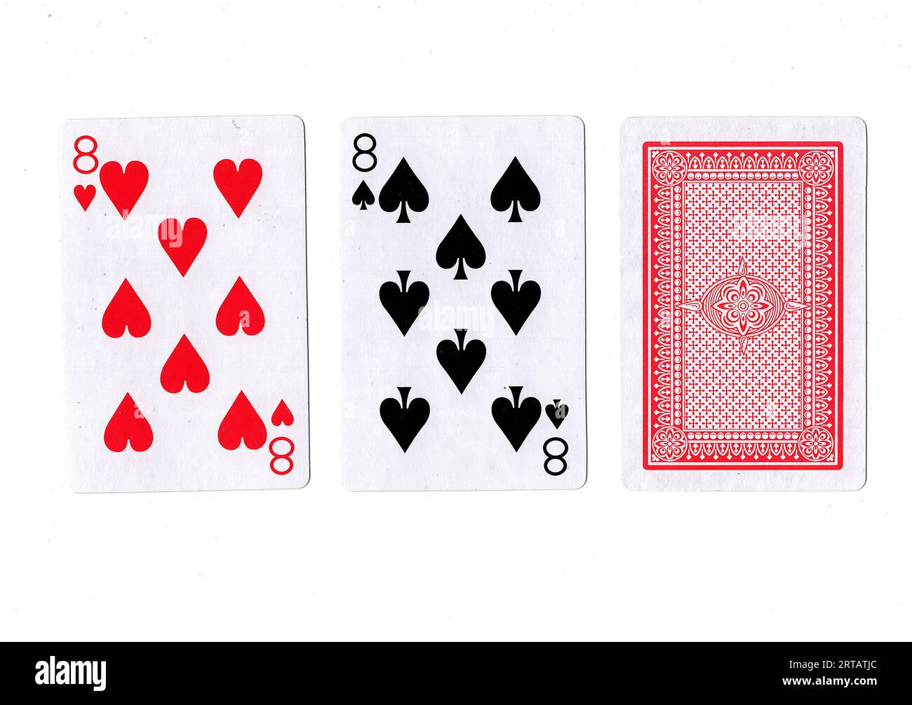 A hand of three playing cards revealing two eights on a white ...