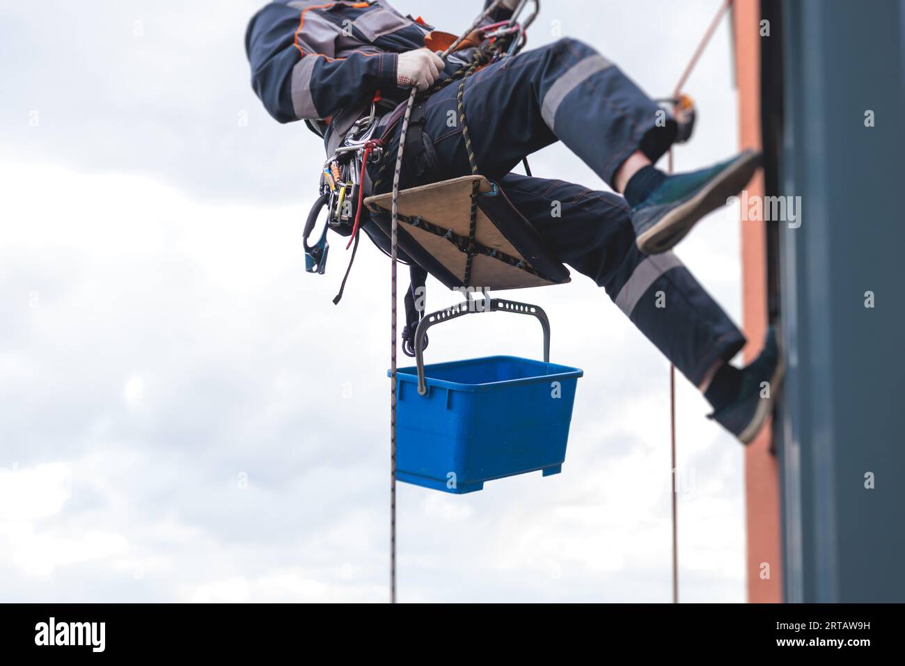 Professional climber rope access worker painting, repairing and ...