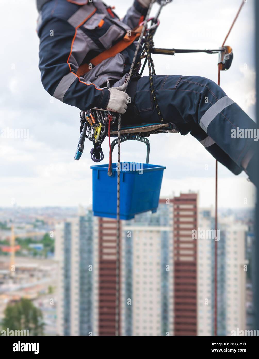 Professional climber rope access worker painting, repairing and ...