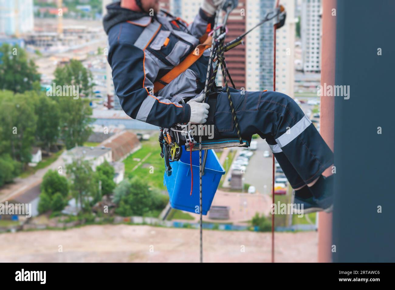 Professional climber rope access worker painting, repairing and ...