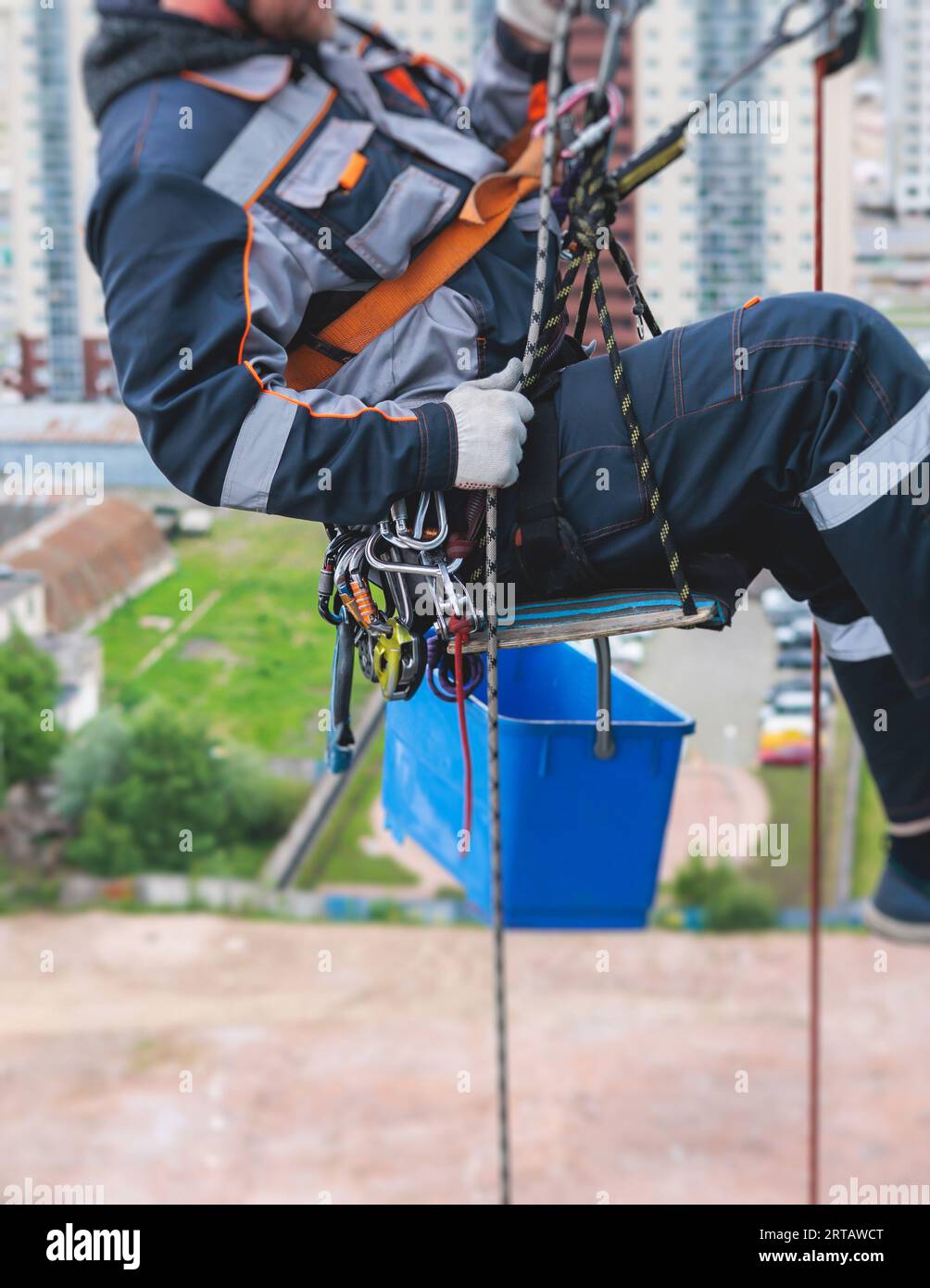 Professional climber rope access worker painting, repairing and ...