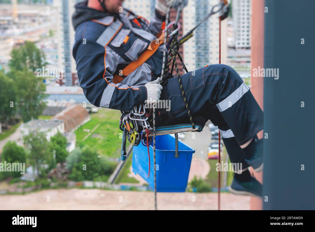 Professional climber rope access worker painting, repairing and ...