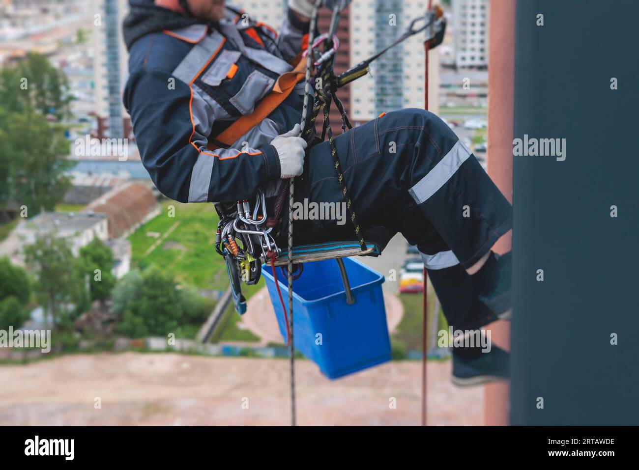 Professional climber rope access worker painting, repairing and ...