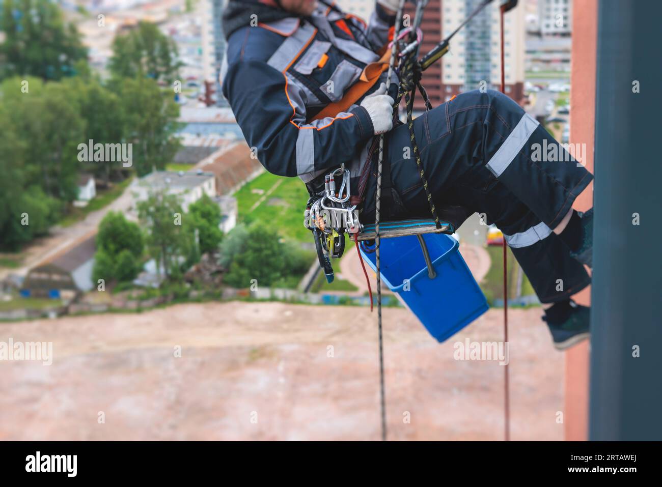 Professional climber rope access worker painting, repairing and ...