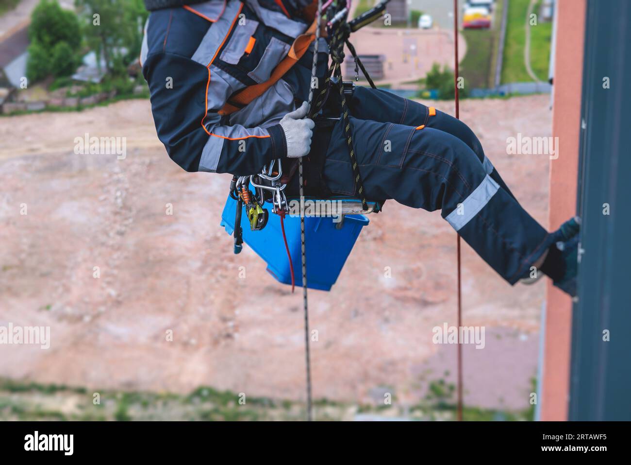 Professional climber rope access worker painting, repairing and ...