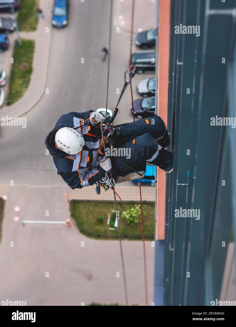 Professional climber rope access worker painting, repairing and ...