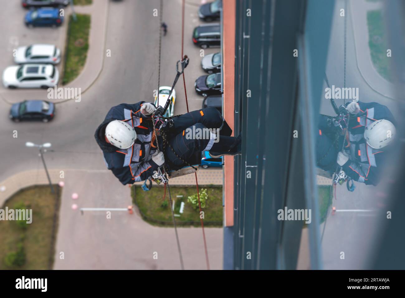 Professional climber rope access worker painting, repairing and ...