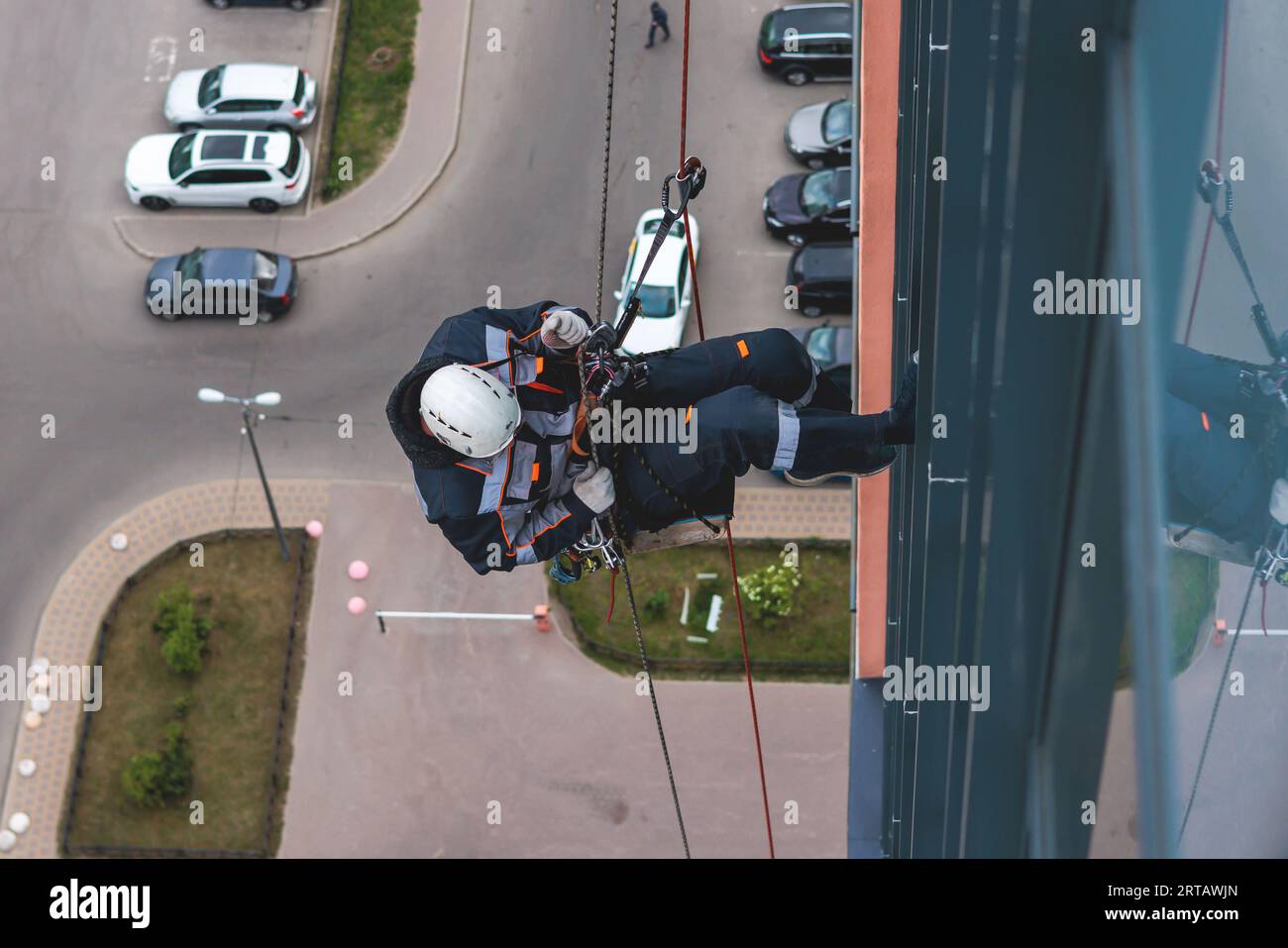 Professional climber rope access worker painting, repairing and ...