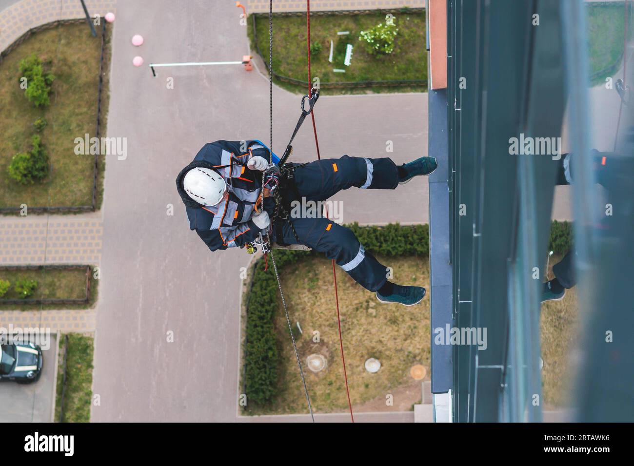 Professional climber rope access worker painting, repairing and ...