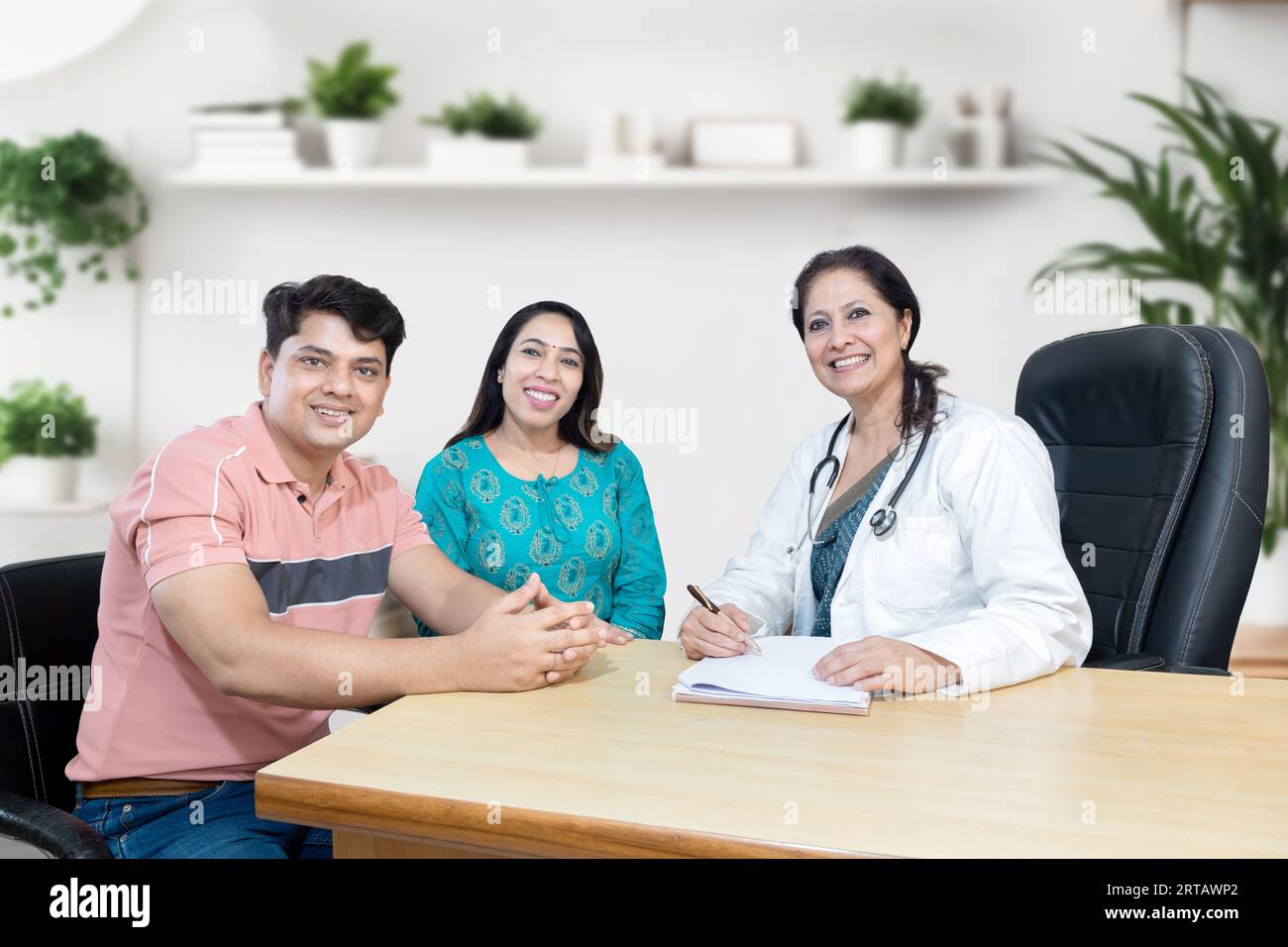 Portrait of Indian female gynecologist doctor consulting young married ...