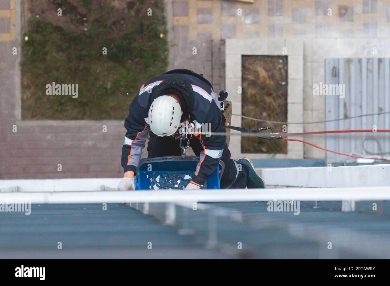 Professional climber rope access worker painting, repairing and ...