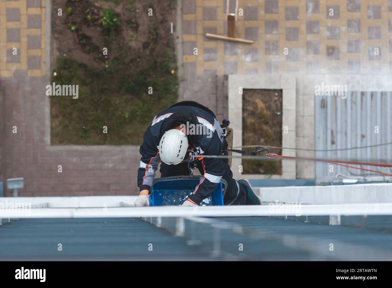 Professional climber rope access worker painting, repairing and ...