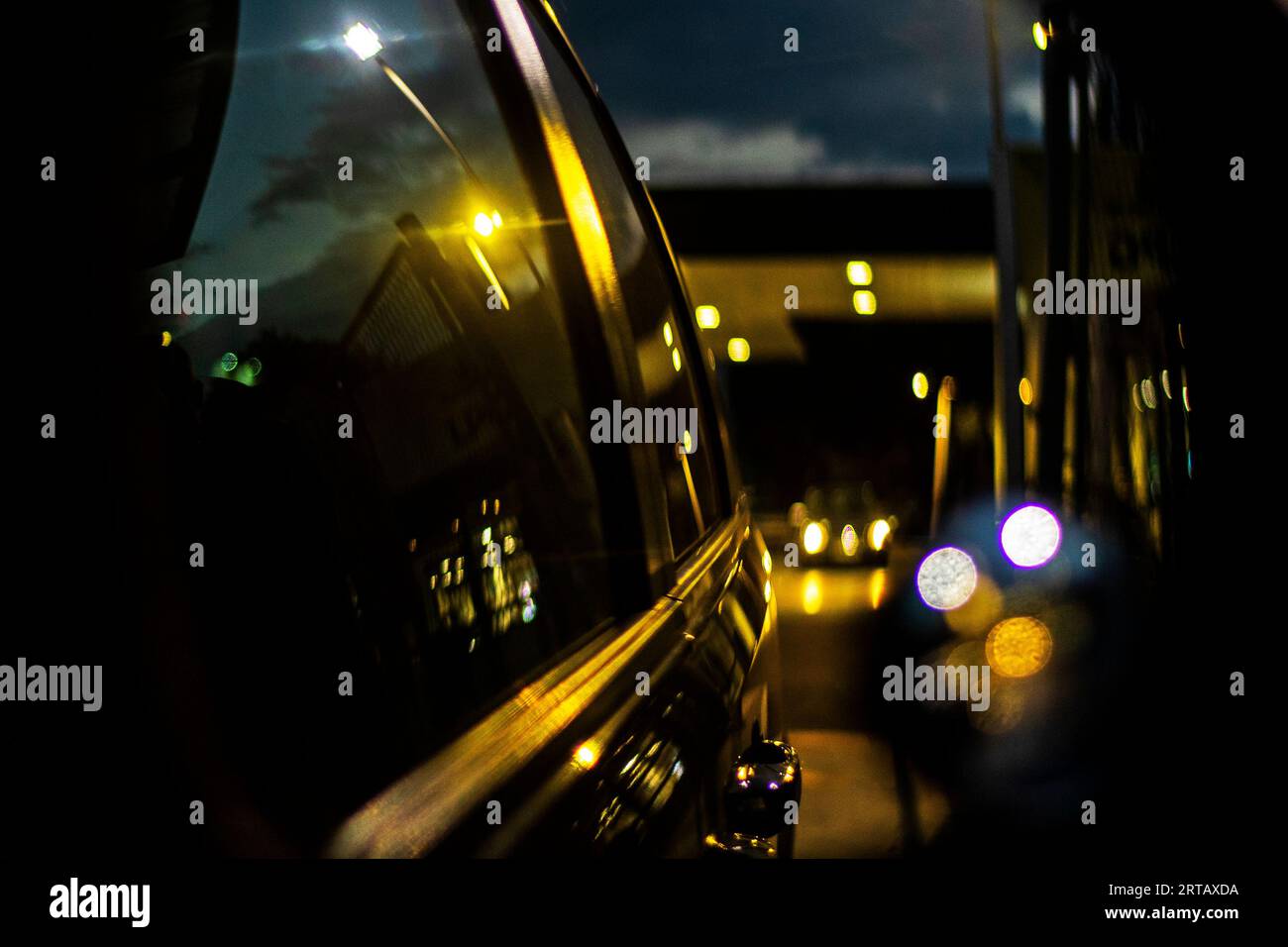 abstract background of side mirror reflection in car road at night ...