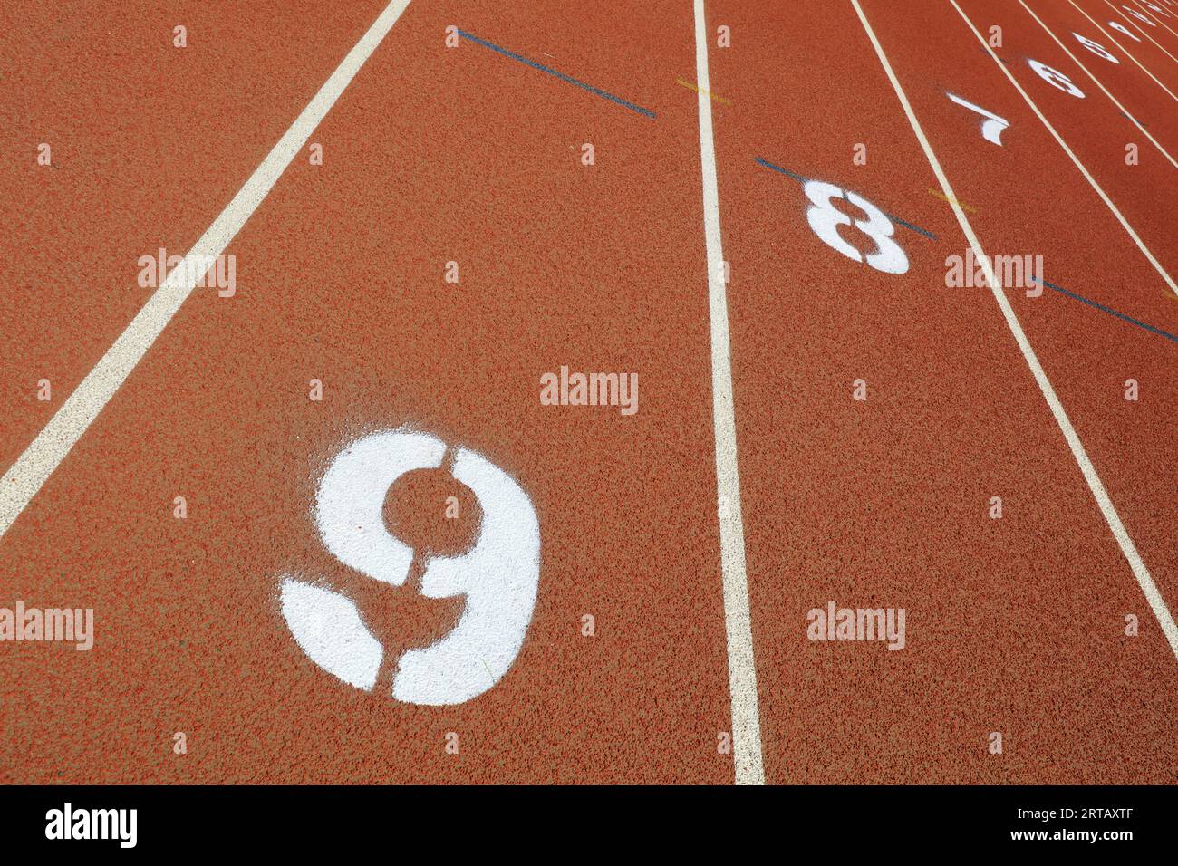 The white numbers on the plastic track are on the playground Stock ...