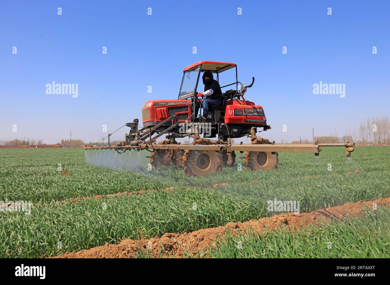 Luannan County - April 10, 2019: self propelled boom sprayer spraying ...