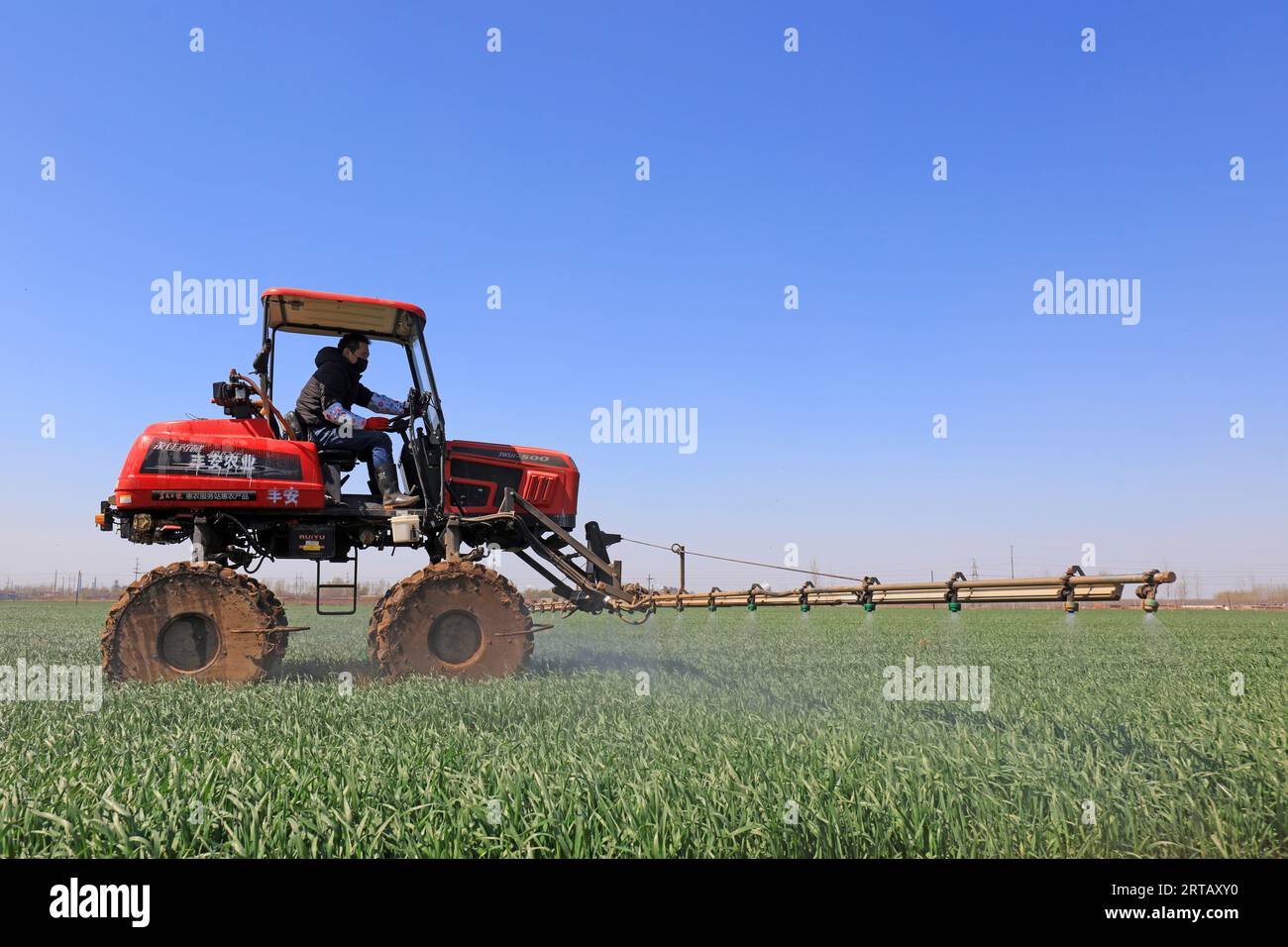 Luannan County - April 10, 2019: self propelled boom sprayer spraying ...