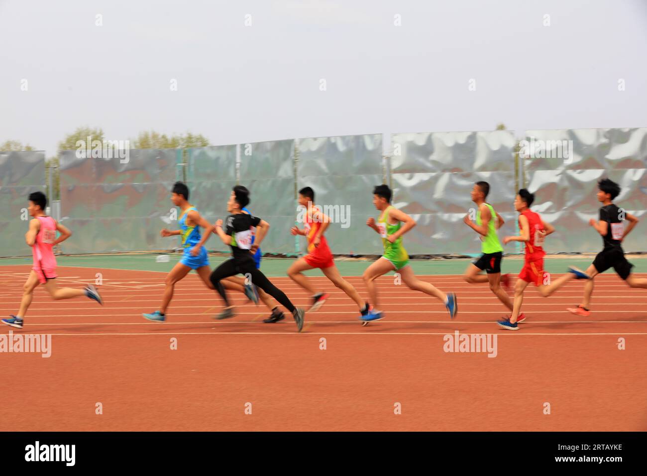 Long distance runners are running on the track Stock Photo - Alamy