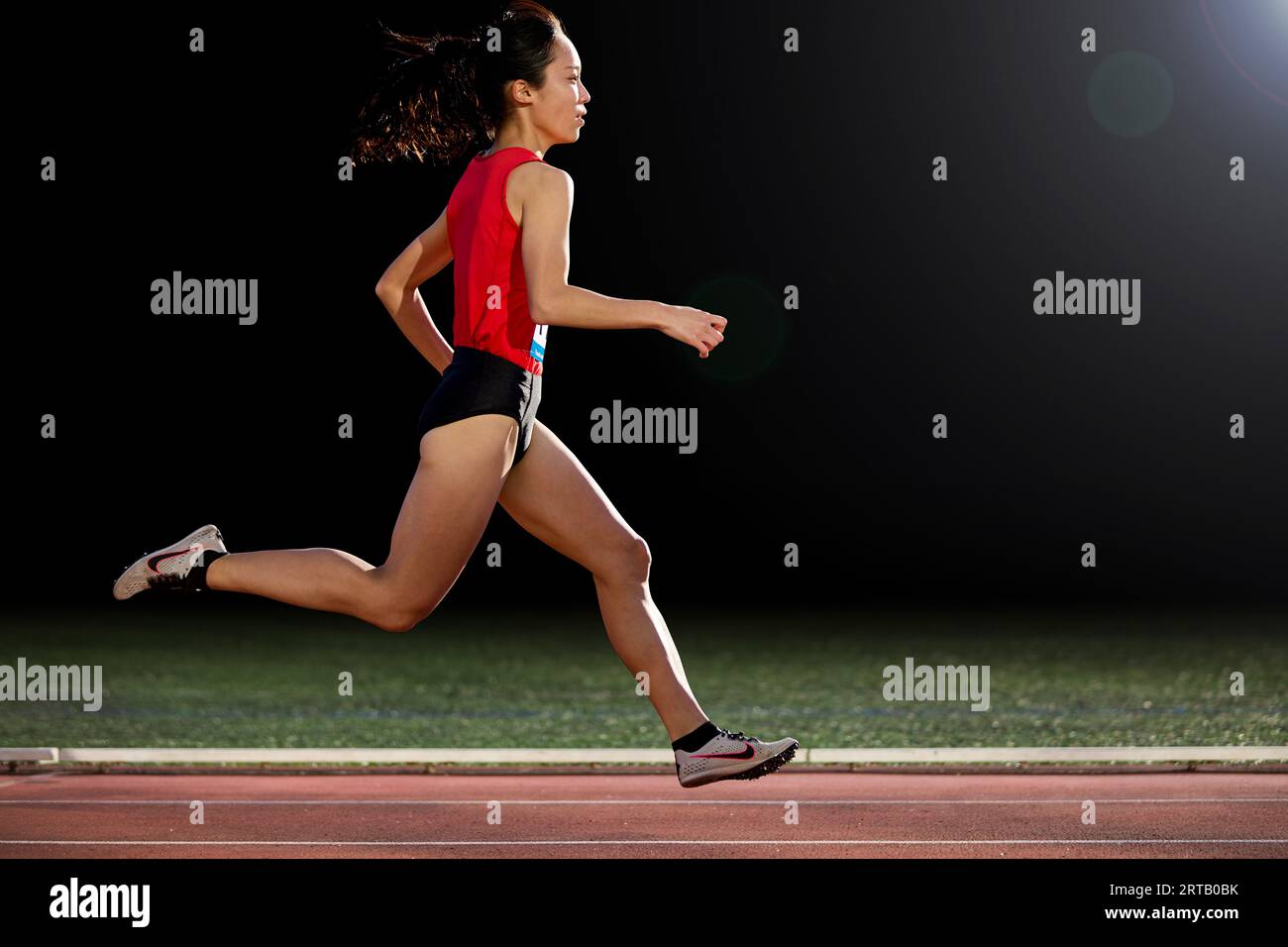 Japanese athlete running on track Stock Photo - Alamy